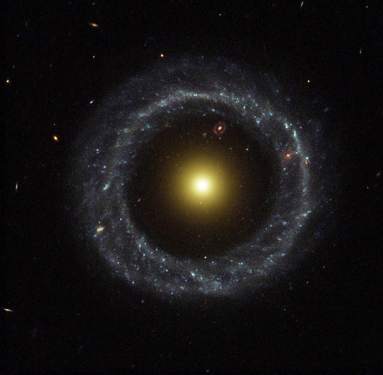 Ring of Hot Blue Stars Pinwheels Around Yellow Nucleus of Hoag's Object ...