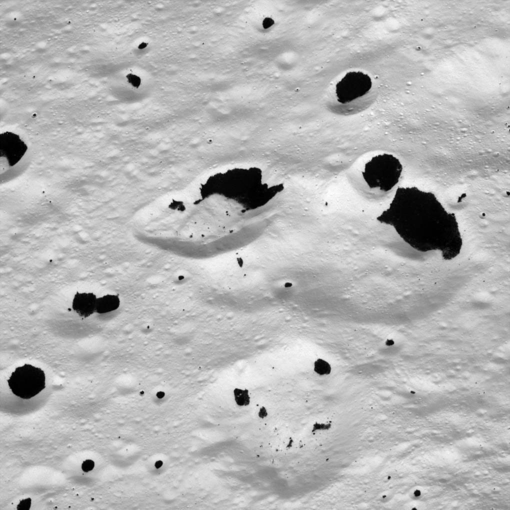 Inky Stains on a Frozen Moon - NASA Science